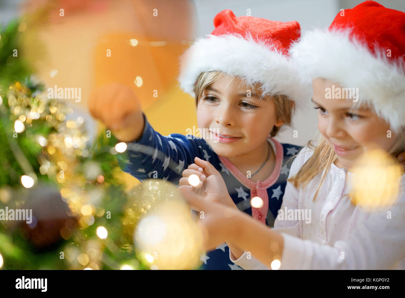 Kids decoration Christmas tree together Stock Photo - Alamy