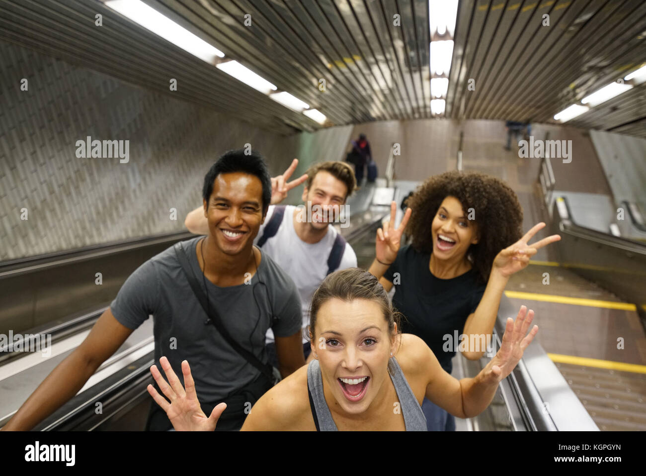 Group of friends having fun in subway stairs Stock Photo - Alamy