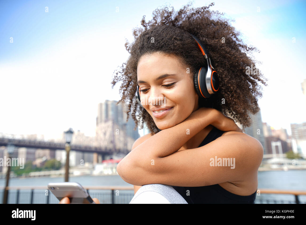 Fitness girl listening to music while working out Stock Photo - Alamy
