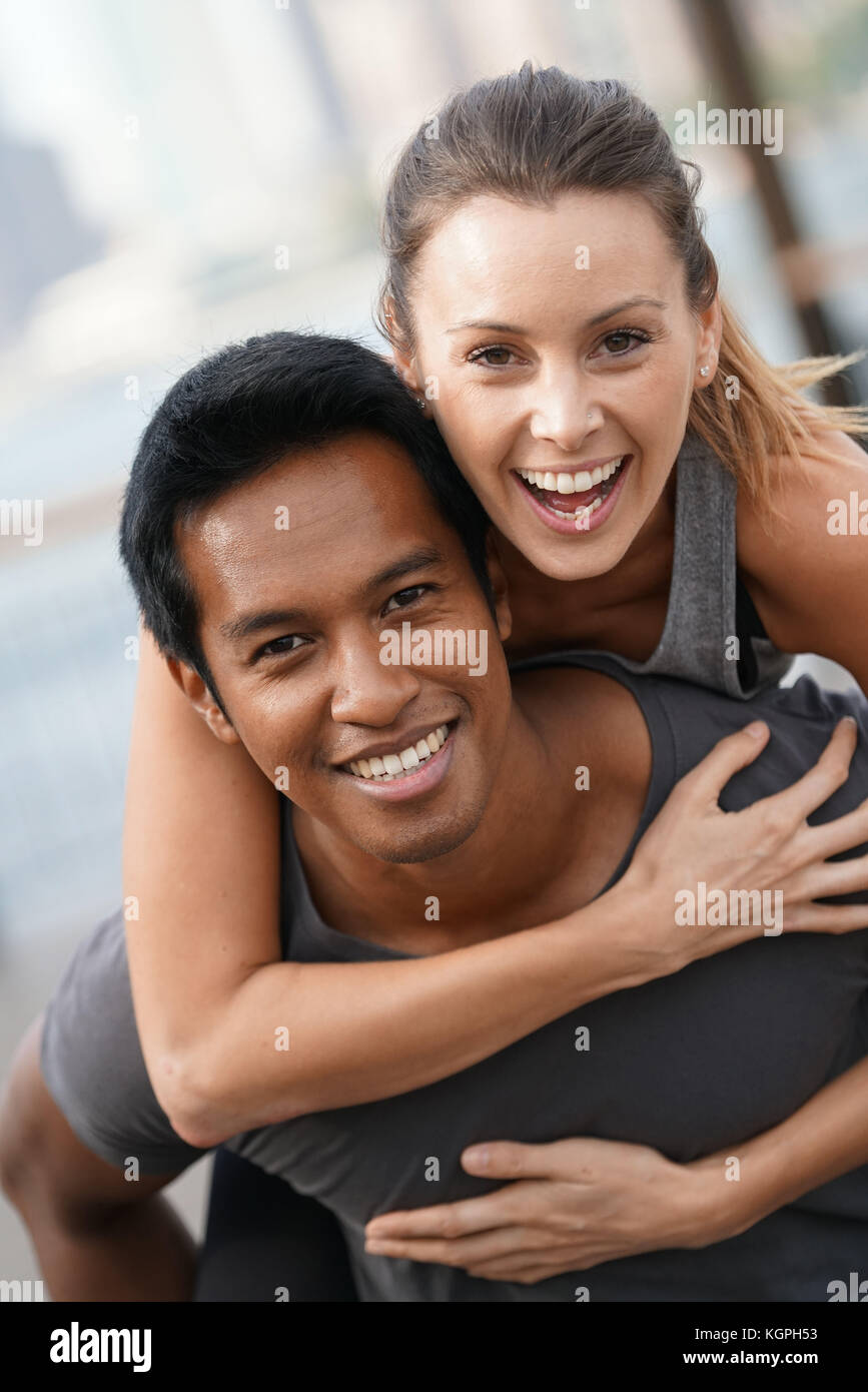 Man giving piggyback ride to girlfriend Stock Photo - Alamy