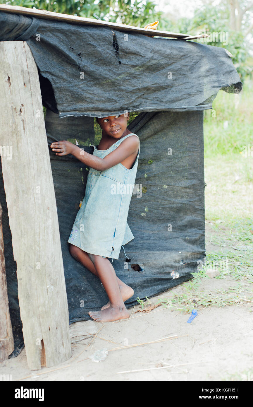 Black african girl having fun outside her school hiding with a tent ...