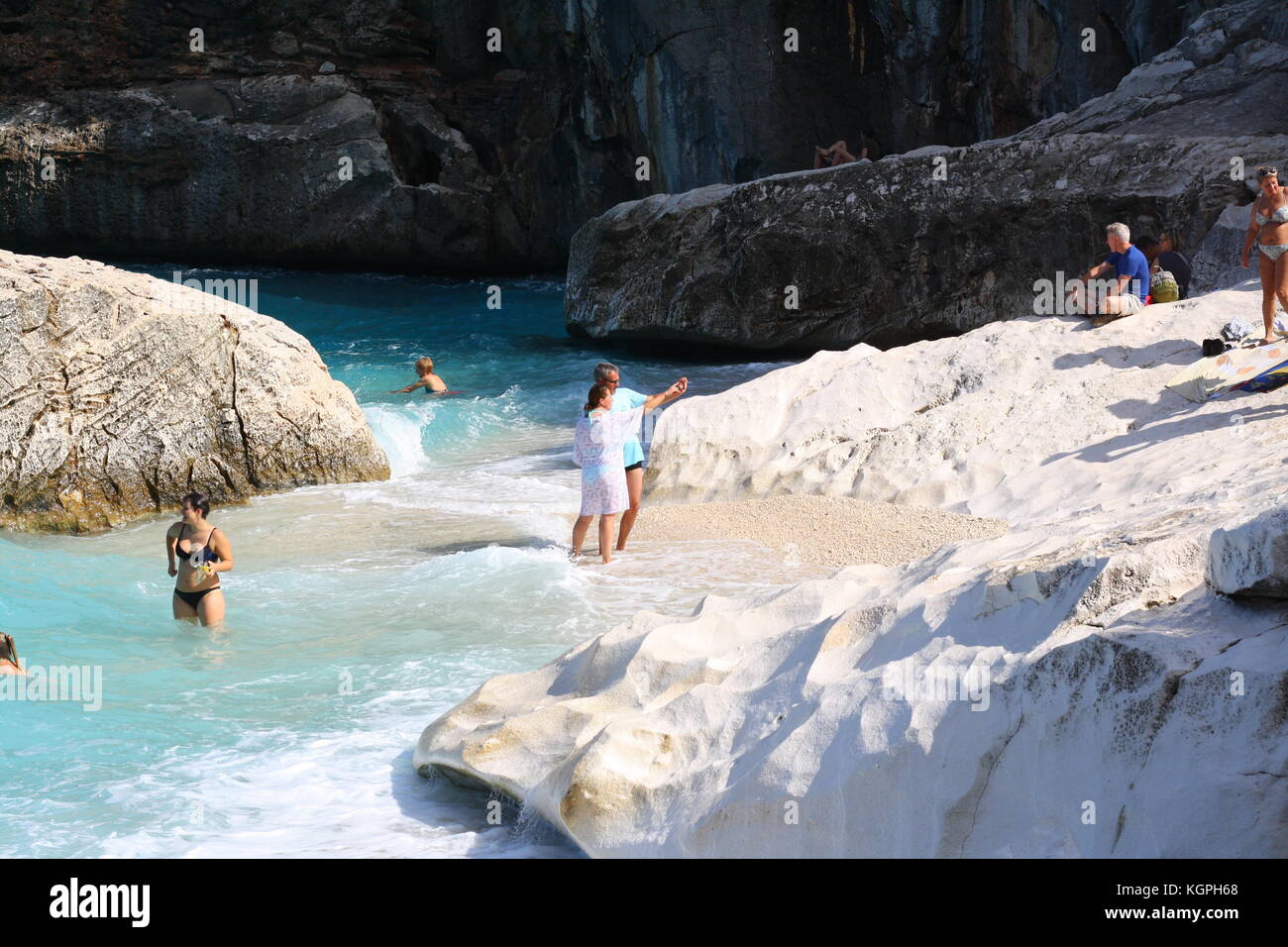 Tourists swimming and bathing at Cala Luna beach in Sardinia, Italy ...