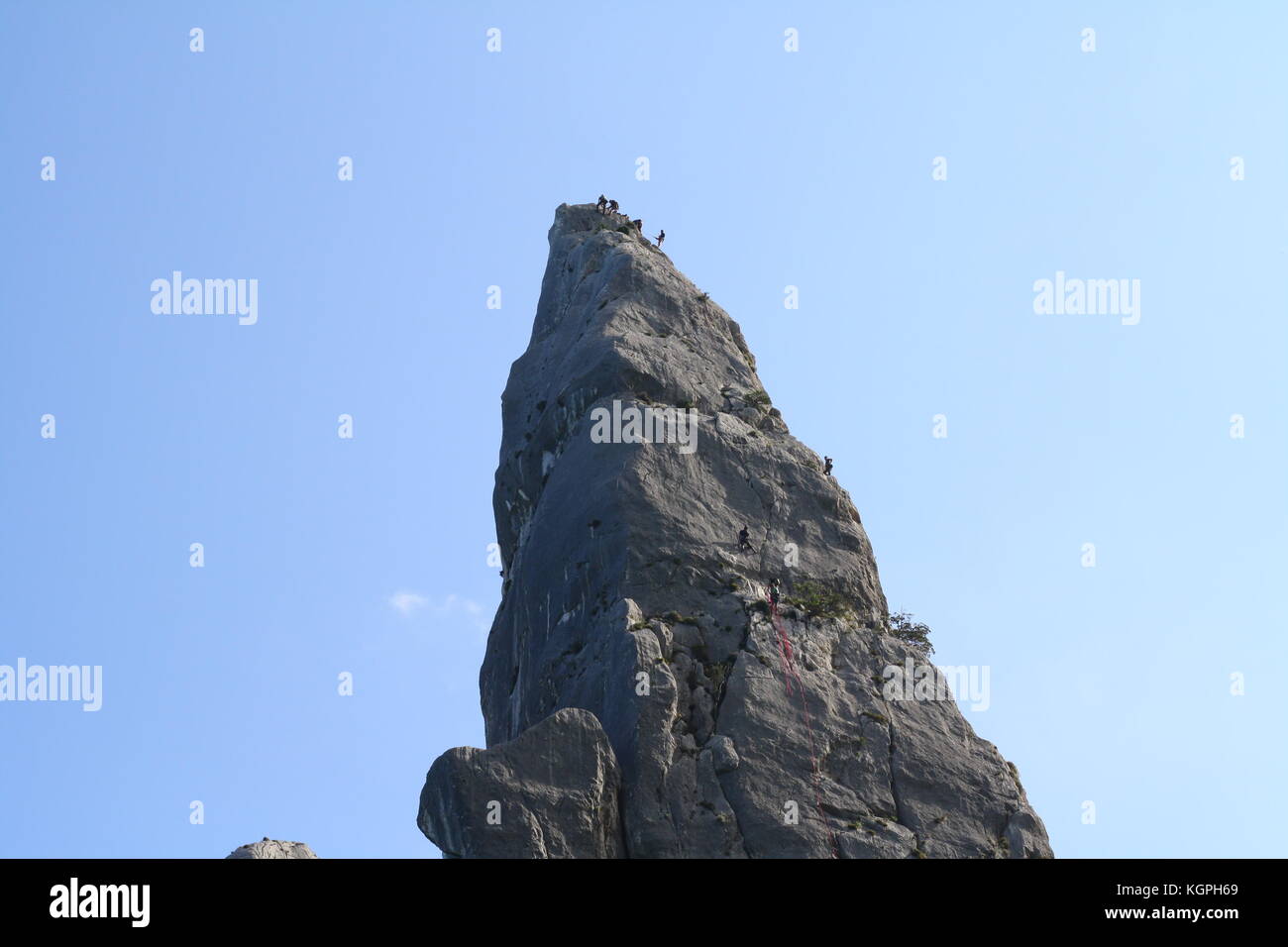 Climbers on a big rock in mountainous terrain in Sardinia, Italy Stock ...