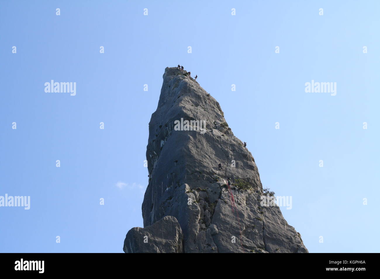 Climbers on a big rock in mountainous terrain in Sardinia, Italy Stock ...