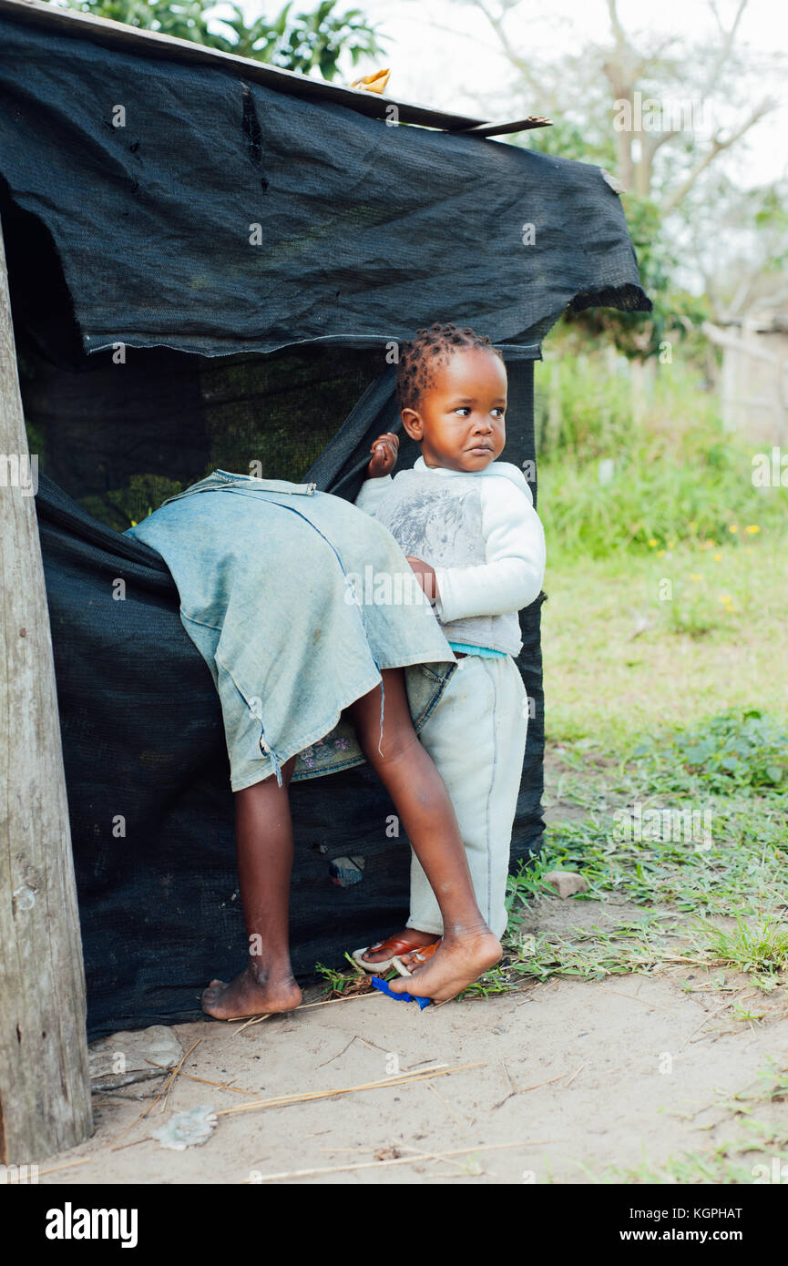 Black african children having fun outside their school hiding with a ...