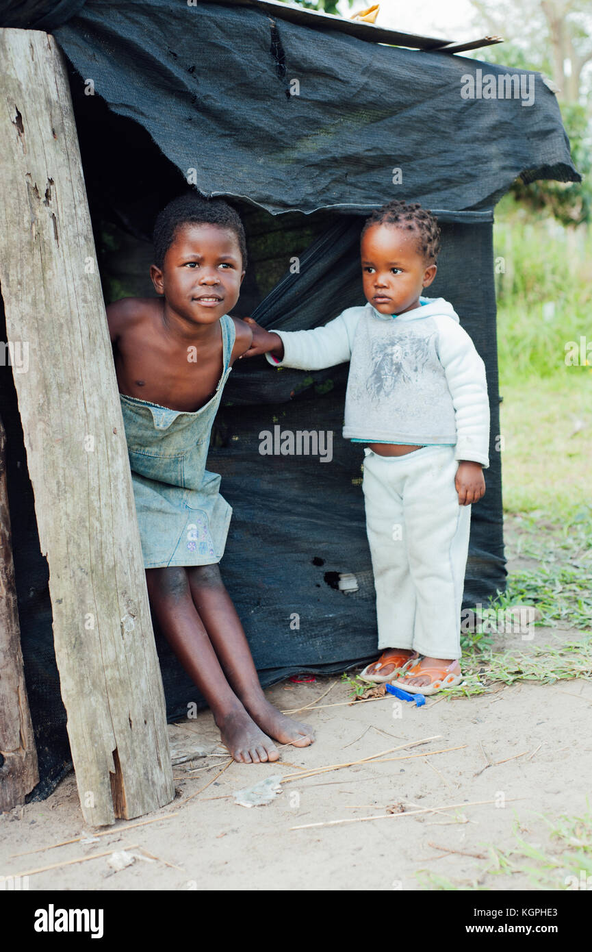 Black african children having fun outside their school hiding with a ...