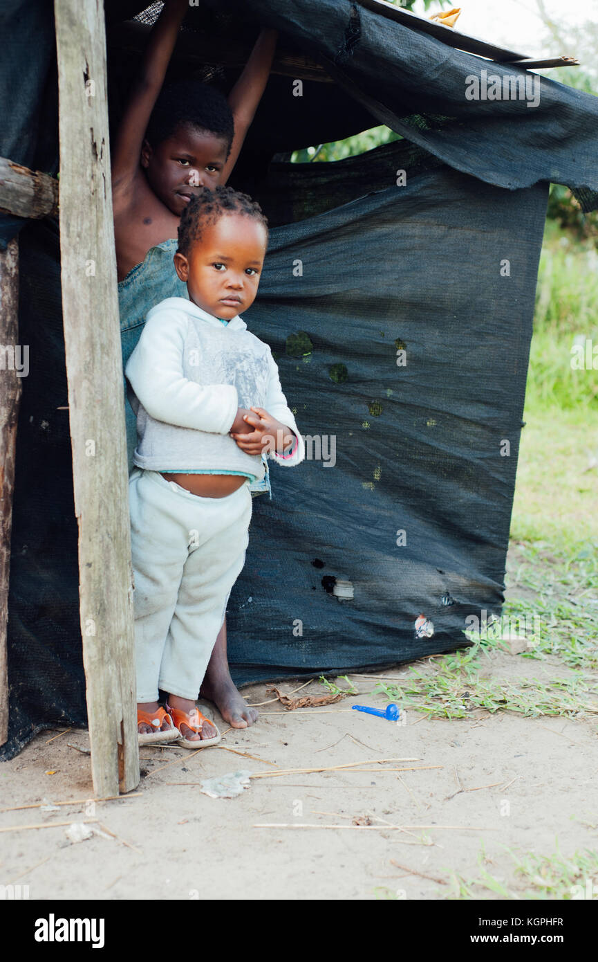 Black african children having fun outside their school hiding with a ...