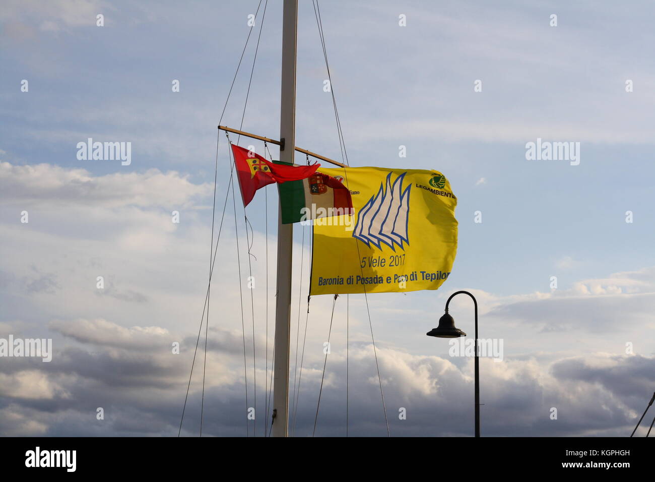 Flags on a sailing boat, yellow one blown by the wind Stock Photo - Alamy