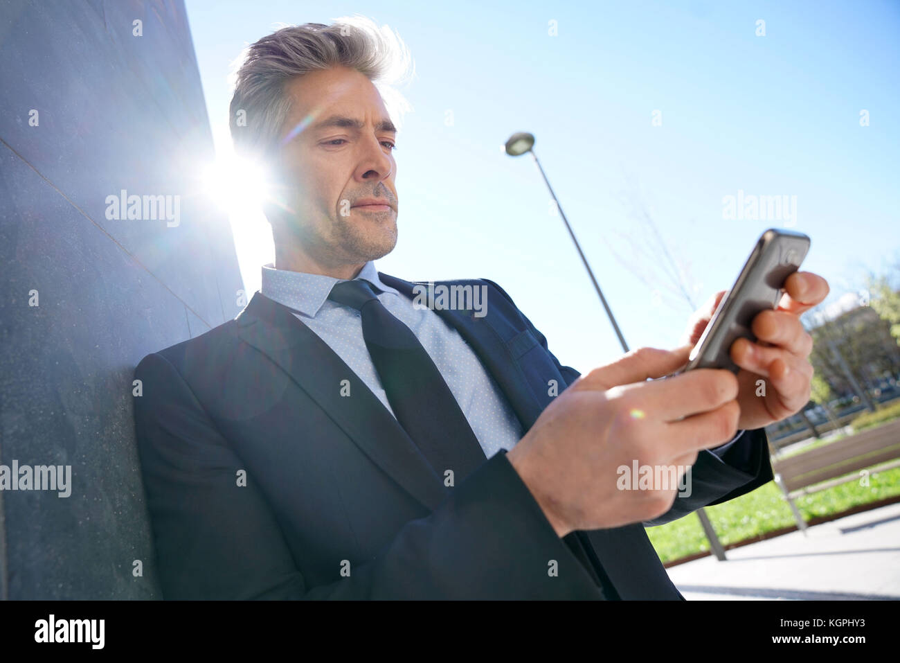 Businessman using pda outside the office Stock Photo - Alamy