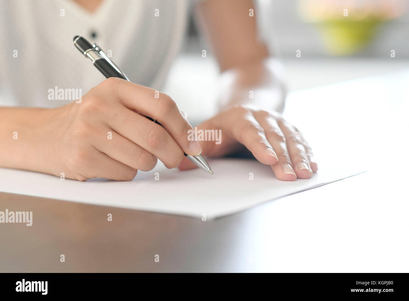 Closeup of woman's hand writing on paper with pen Stock Photo - Alamy