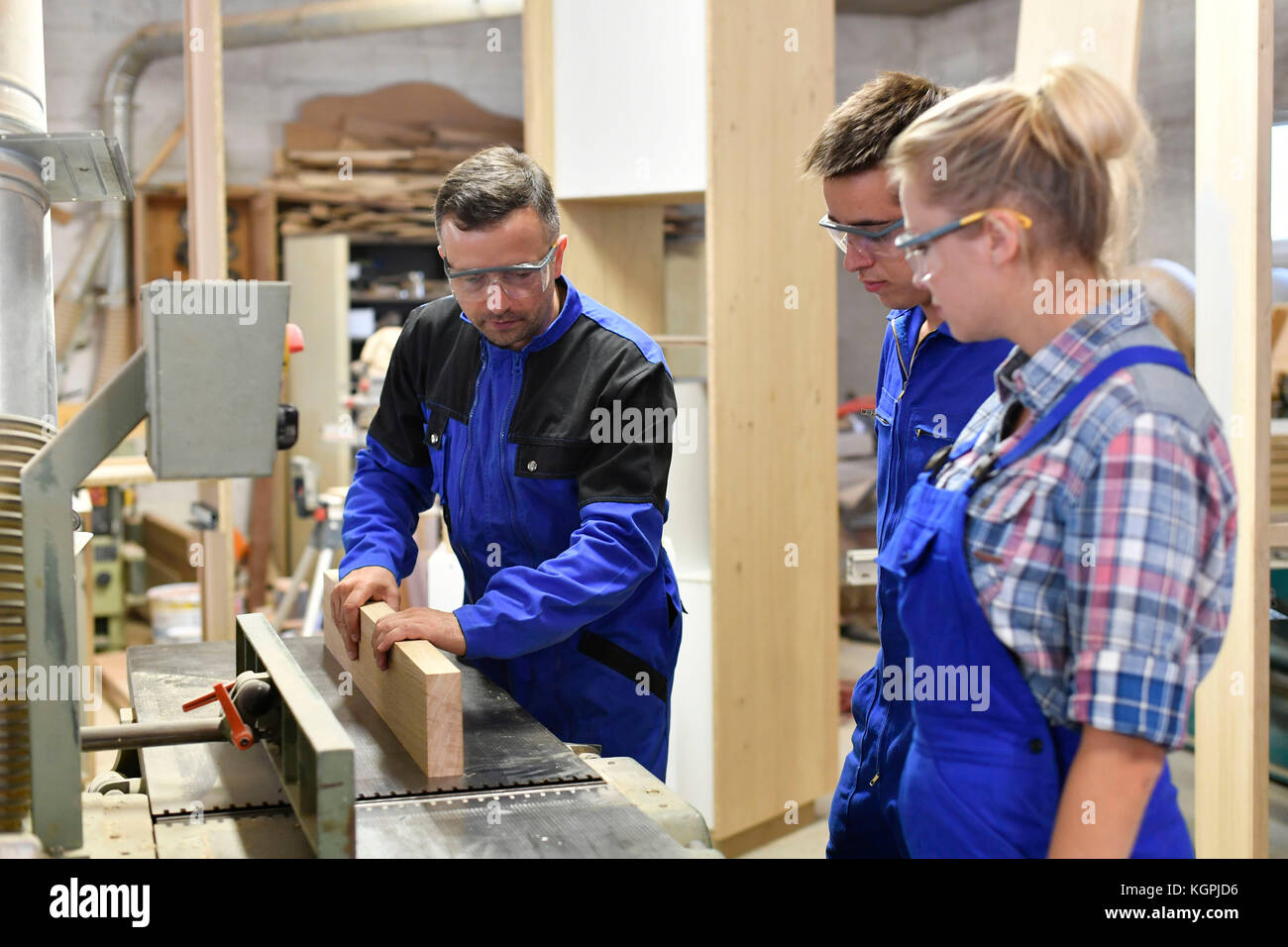 Carpenter with apprentice in workshop Stock Photo - Alamy