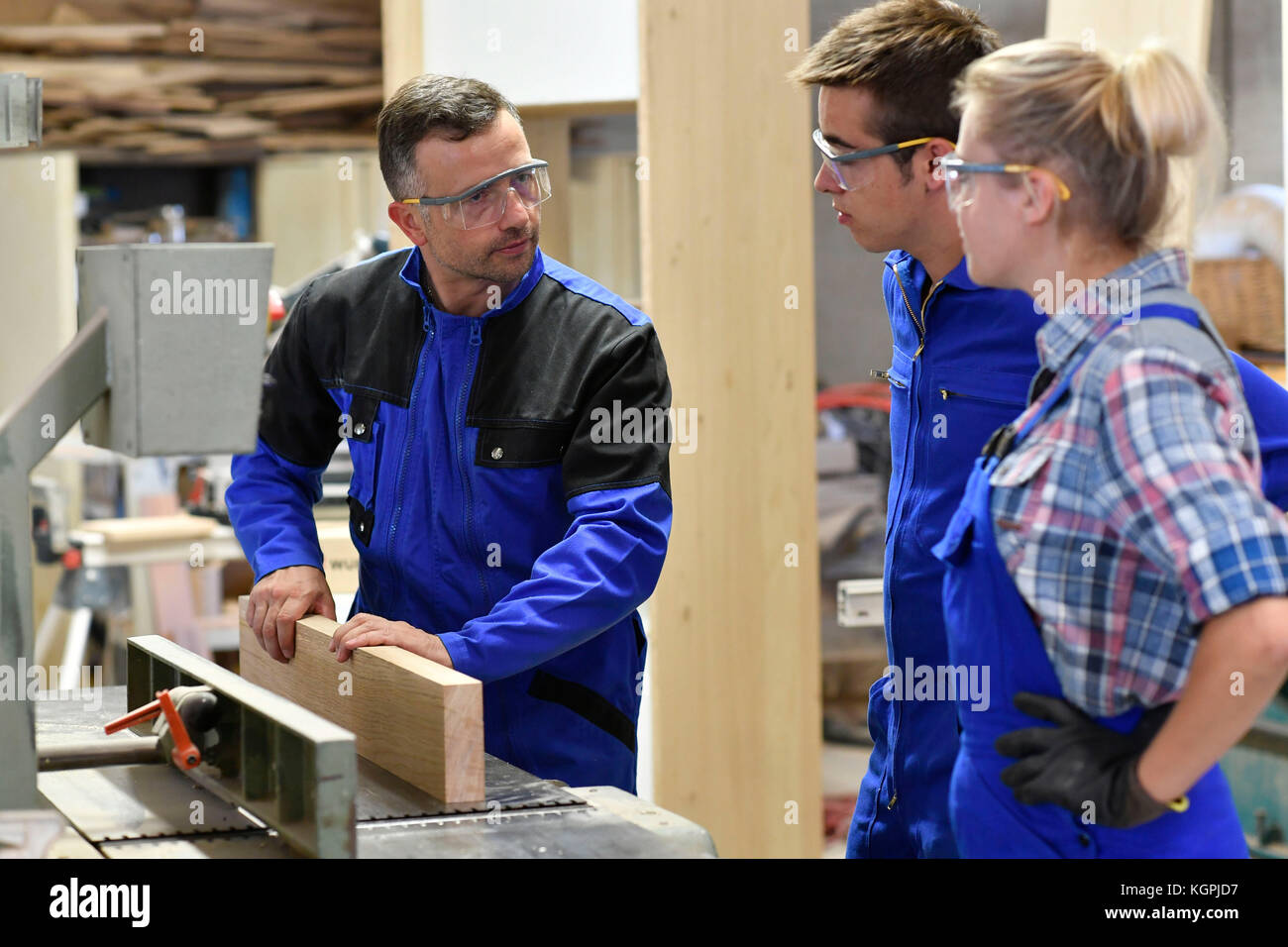 Carpenter with apprentice in workshop Stock Photo - Alamy