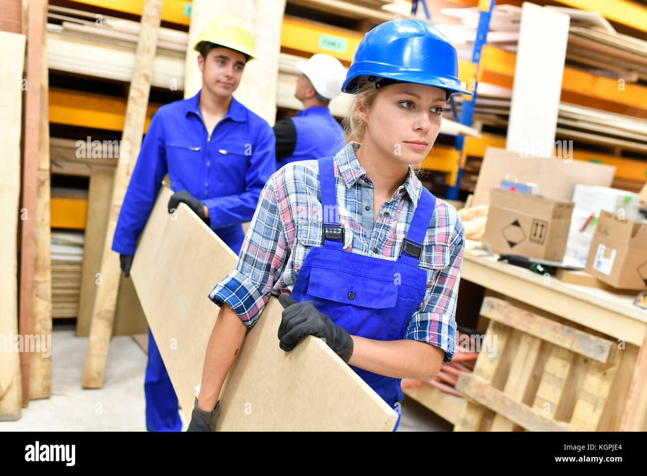 Students in carpentry apprenticeship carrying wood Stock Photo - Alamy