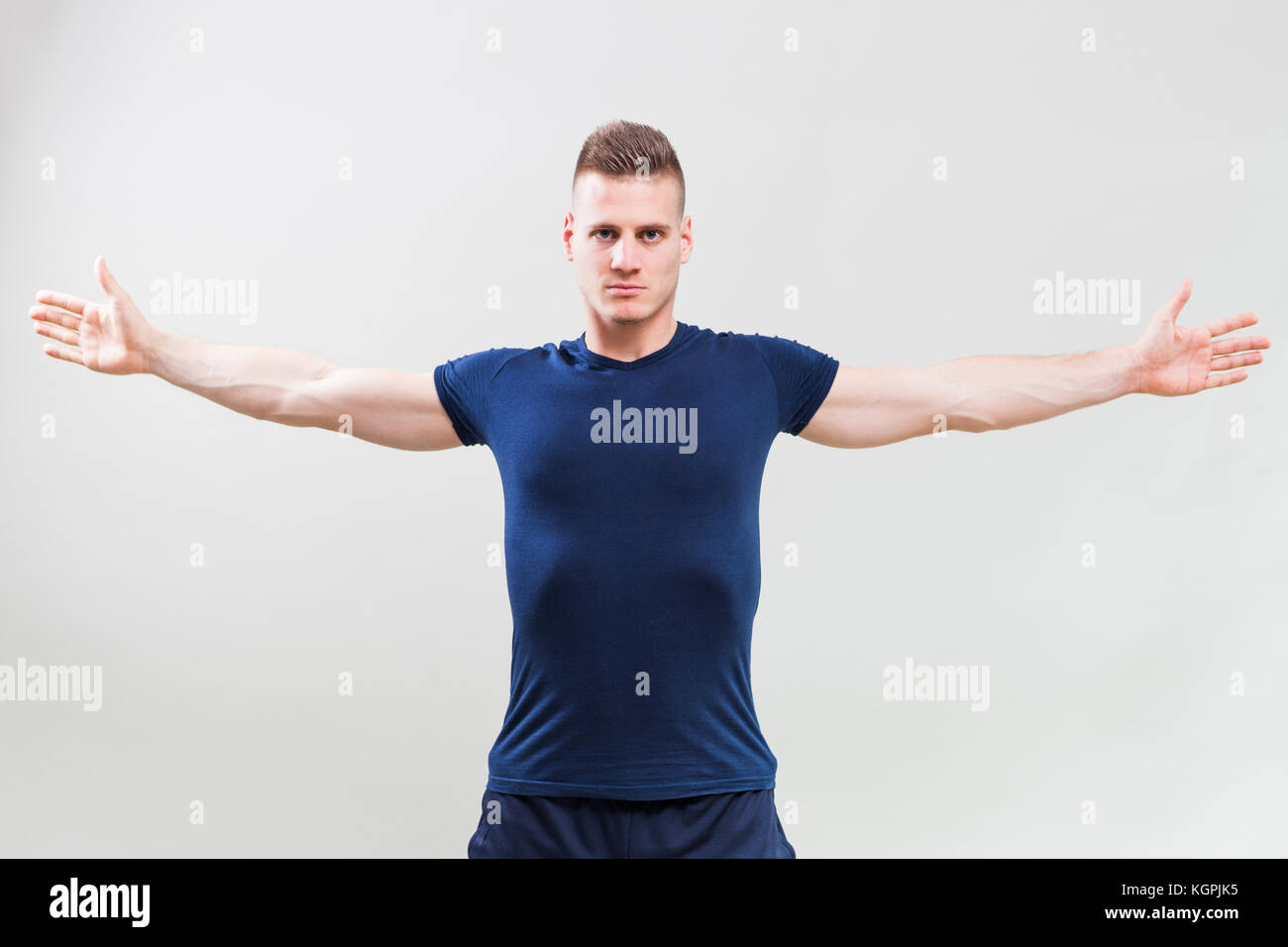 Studio shot image of young man who is stretching his body Stock Photo ...