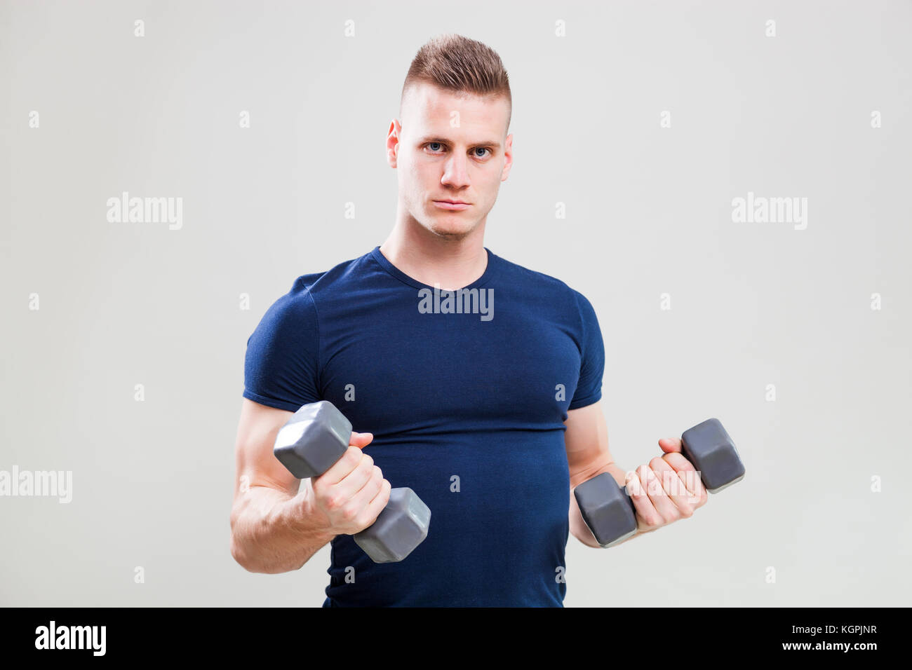 Studio shot image of young man who is exercising with weights Stock ...