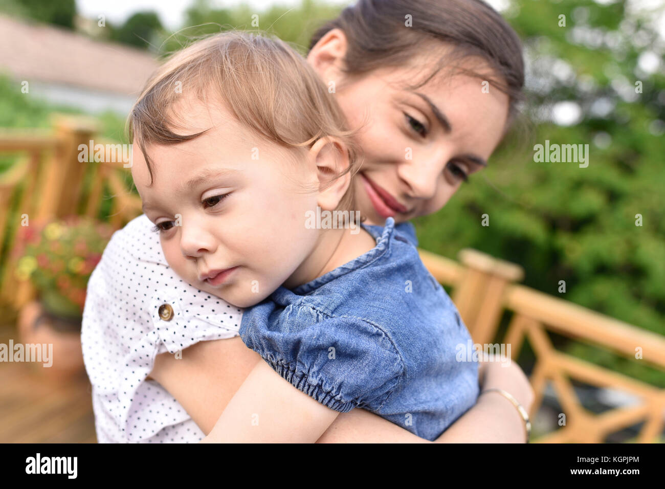 Little girl giving her mom a hug Stock Photo - Alamy