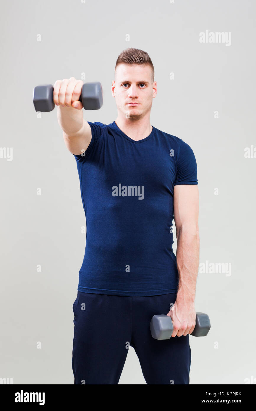 Studio shot image of young man who is exercising with weights Stock ...