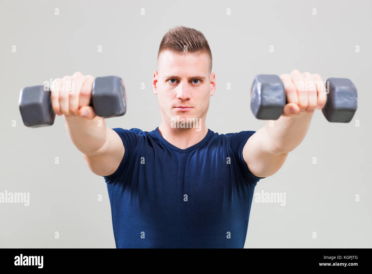 Studio shot image of young man who is exercising with weights Stock ...