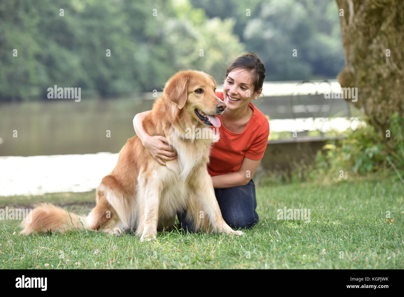 Woman relaxing with dog at the park Stock Photo - Alamy