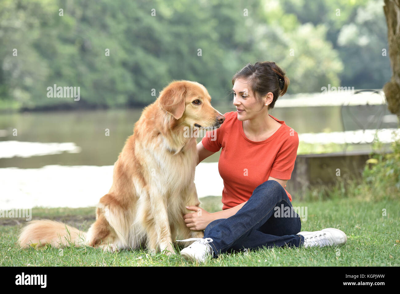 Woman relaxing with dog at the park Stock Photo - Alamy