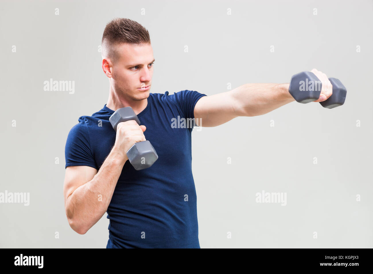 Studio shot image of young man who is exercising with weights Stock ...
