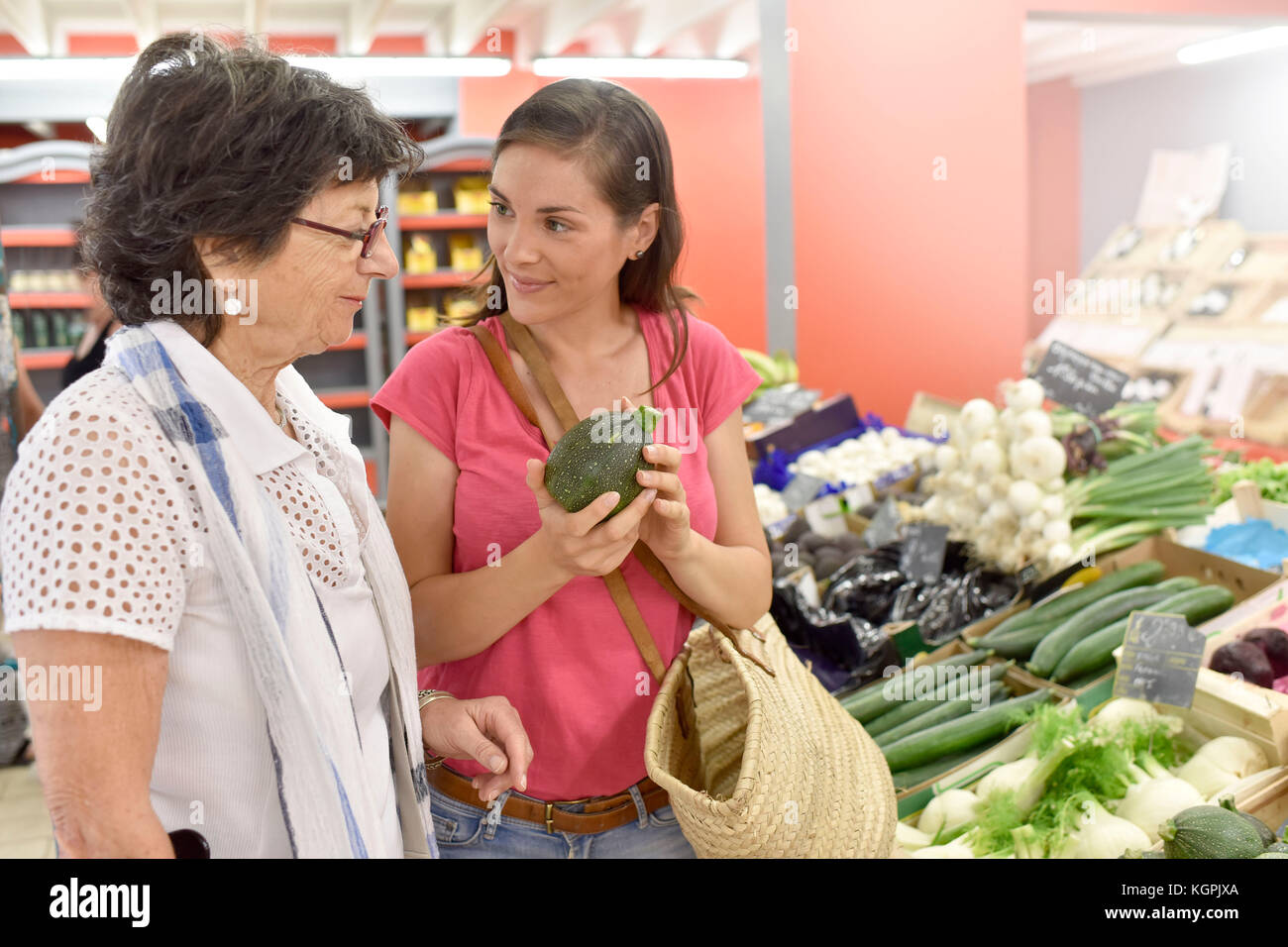 Senior woman going to grocery store with help of carer Stock Photo - Alamy