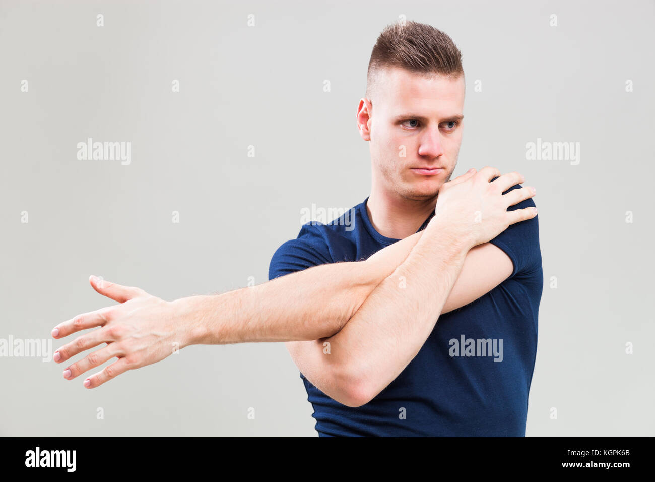 Studio shot image of young man who is stretching his body Stock Photo ...