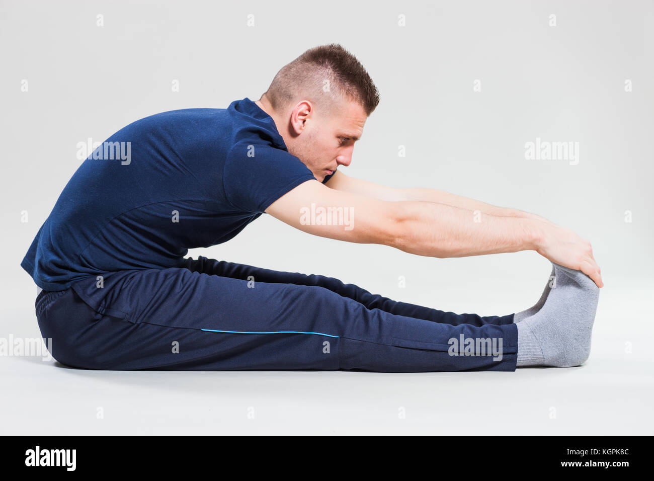 Studio shot image of young man who is stretching his body Stock Photo ...