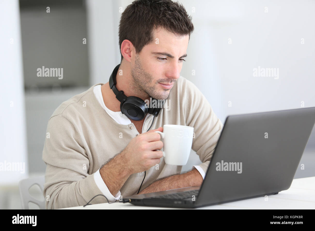 Man in front of laptop computer with headset Stock Photo - Alamy