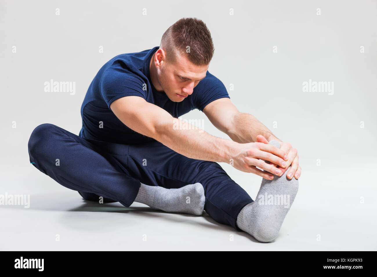 Studio shot image of young man who is stretching his body Stock Photo ...