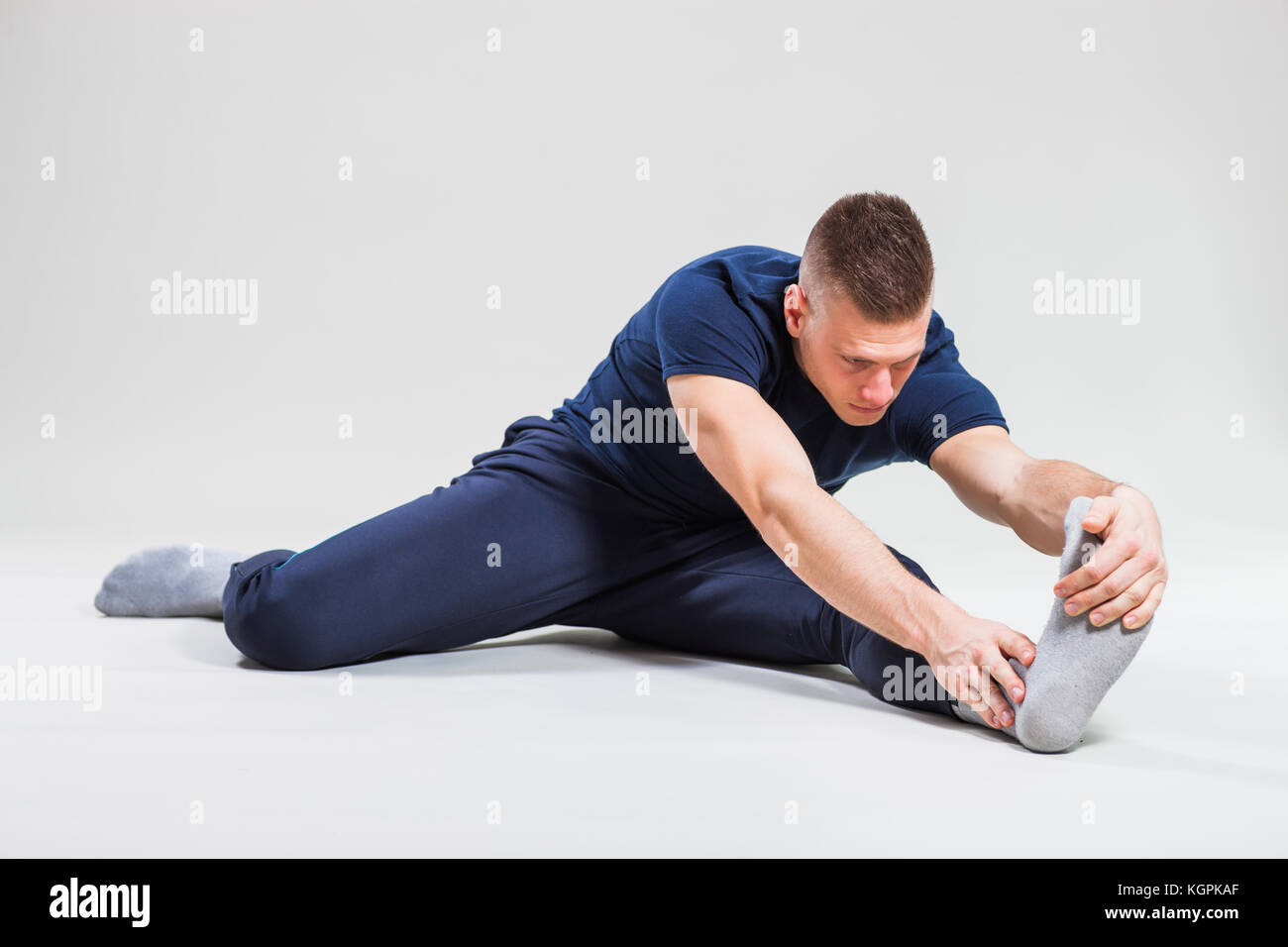 Studio shot image of young man who is stretching his body Stock Photo ...