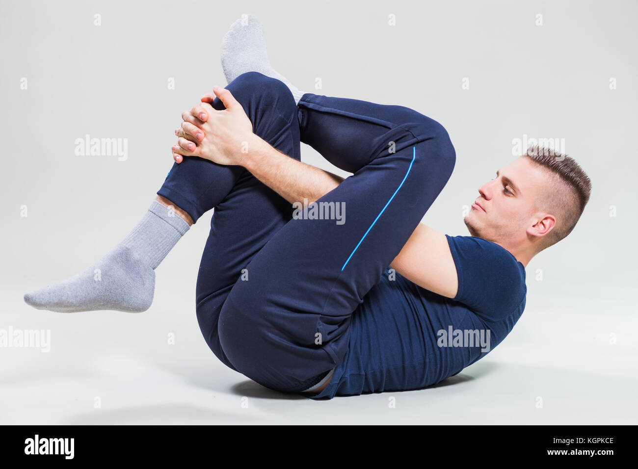 Studio shot image of young man who is stretching his body Stock Photo ...