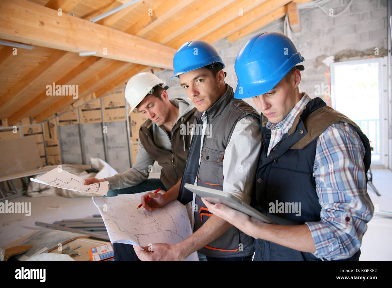Construction manager with workers checking on site Stock Photo - Alamy
