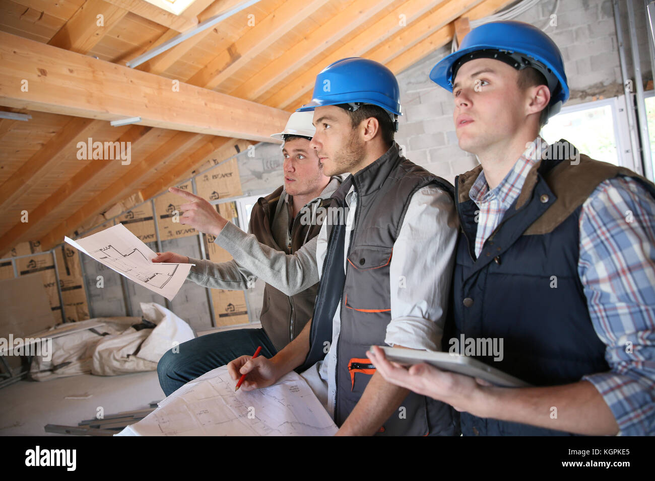 Construction manager with workers checking on site Stock Photo - Alamy