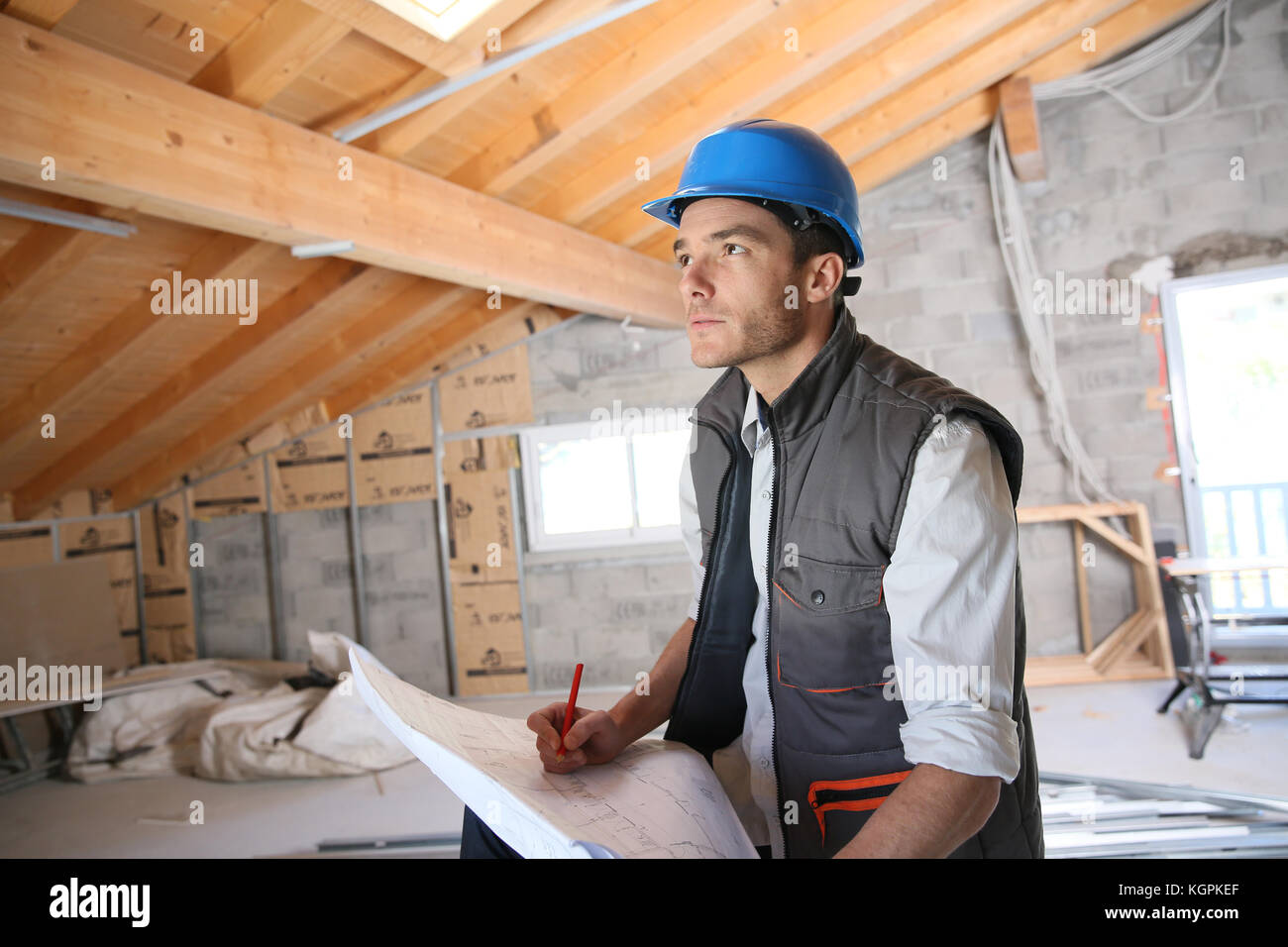 Construction manager on site reading blueprint Stock Photo - Alamy