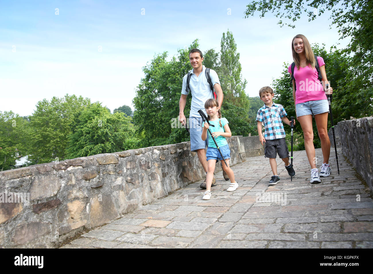 Family on a rambling journey crossing roman bridge Stock Photo - Alamy