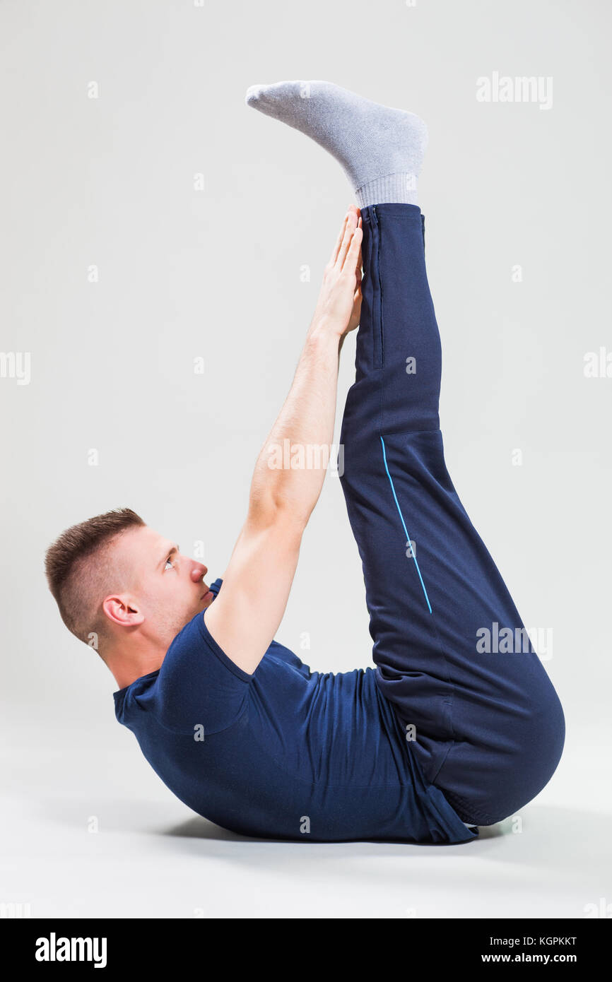 Studio shot image of young man who is stretching his body Stock Photo ...