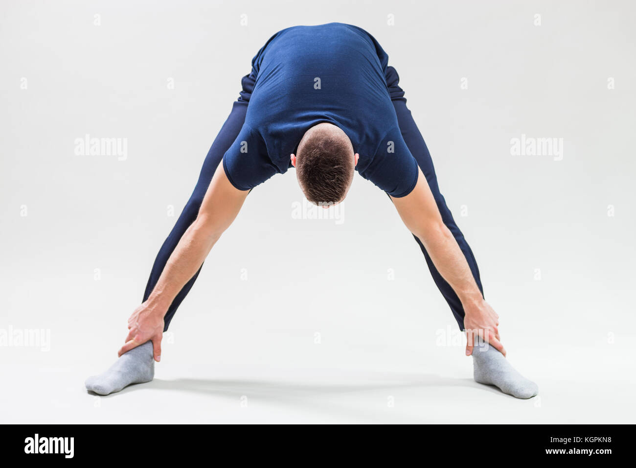Studio shot image of young man who is stretching his body Stock Photo ...