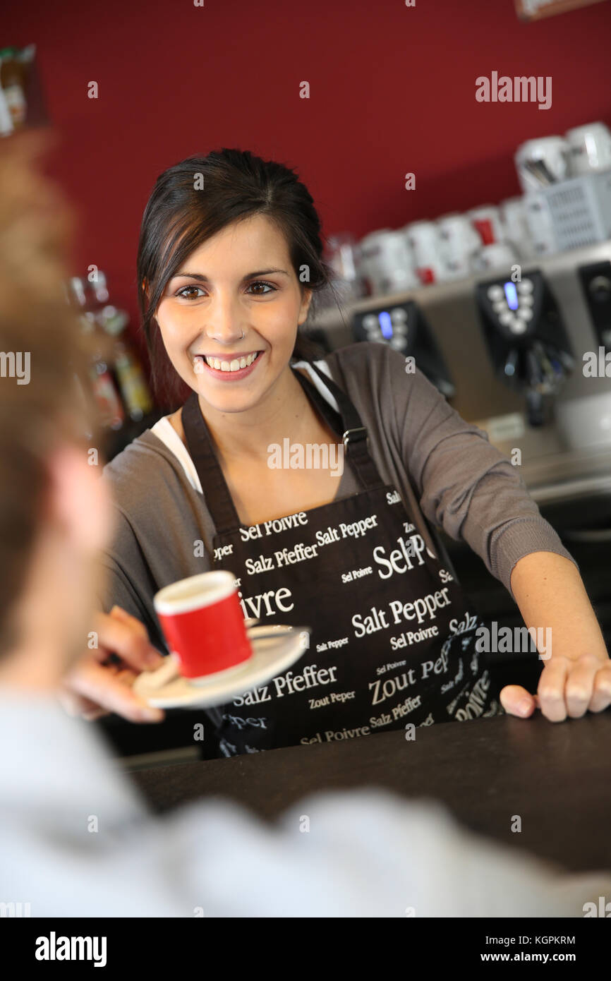 Waitress serving coffee from machine Stock Photo - Alamy