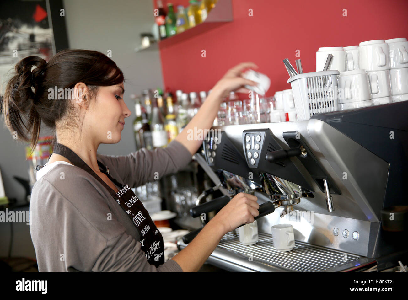 Waitress serving coffee from machine Stock Photo - Alamy