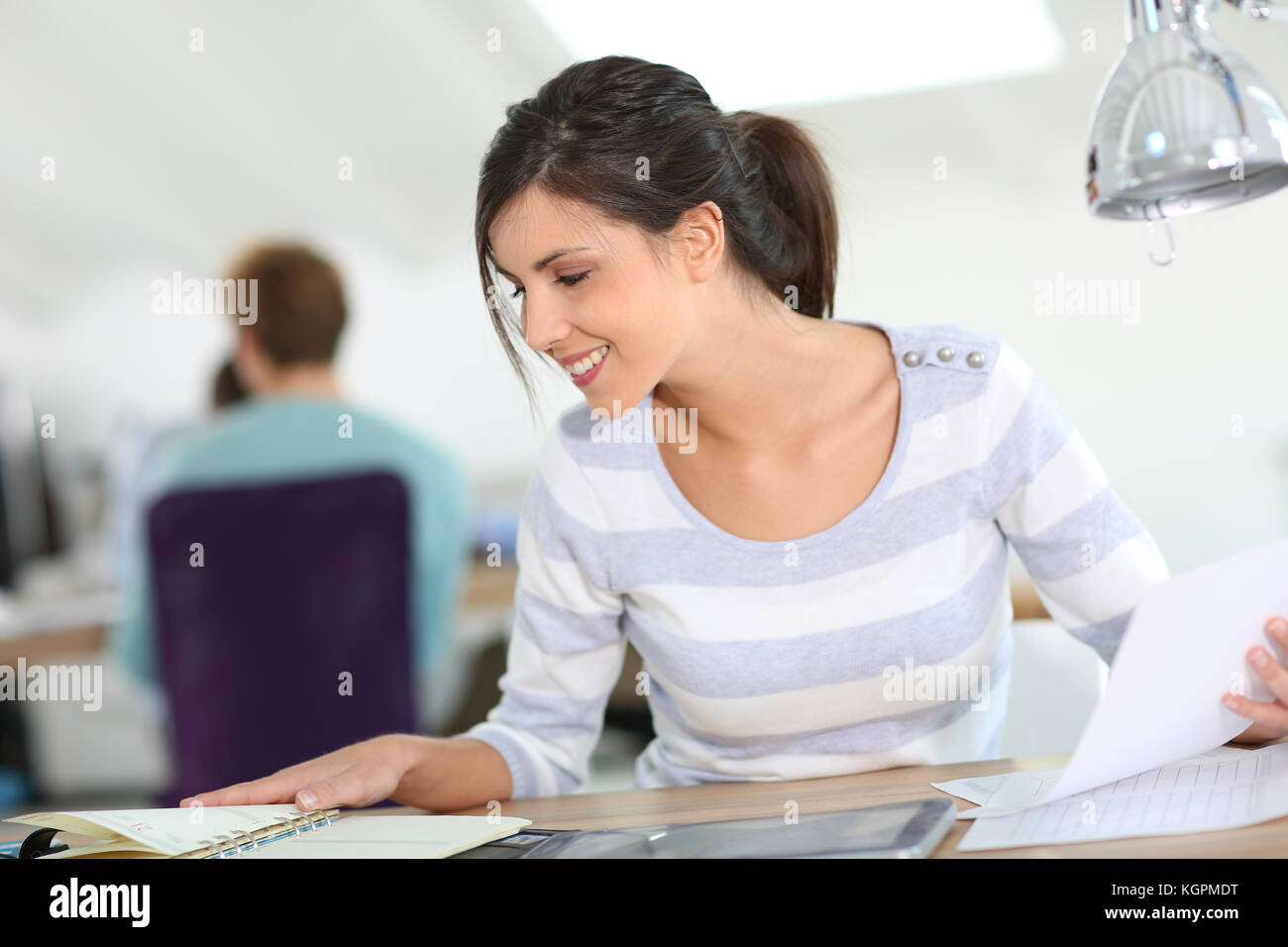 Young woman in class preparing exam Stock Photo - Alamy