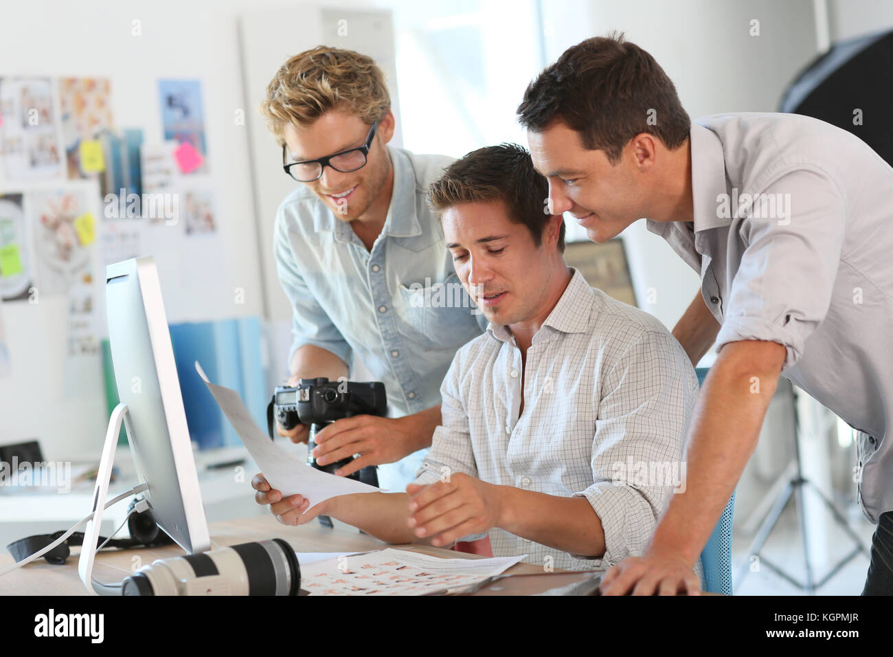 Creative team of photographers meeting with client Stock Photo - Alamy