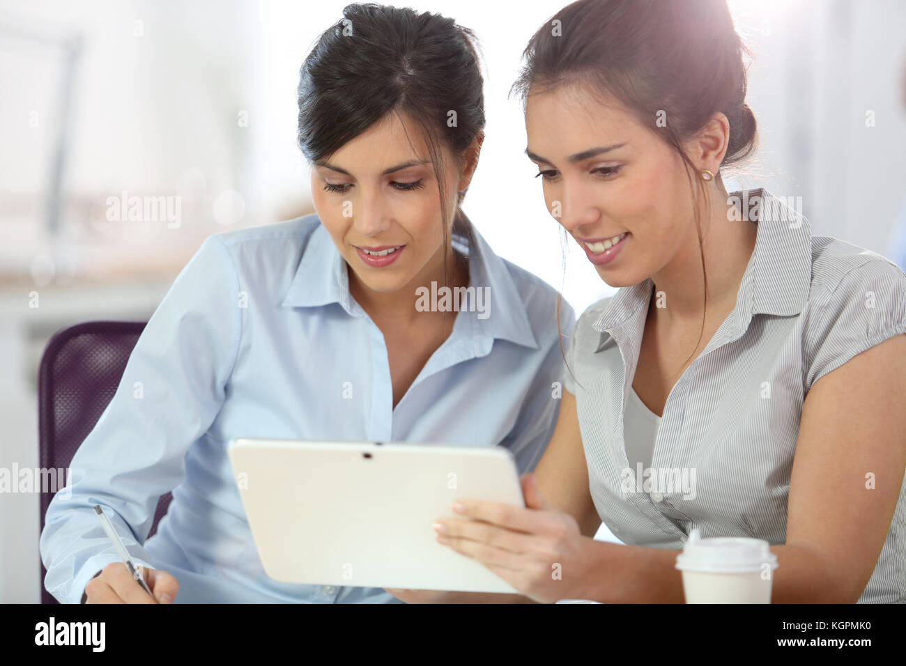 Young business girls working together on project Stock Photo - Alamy