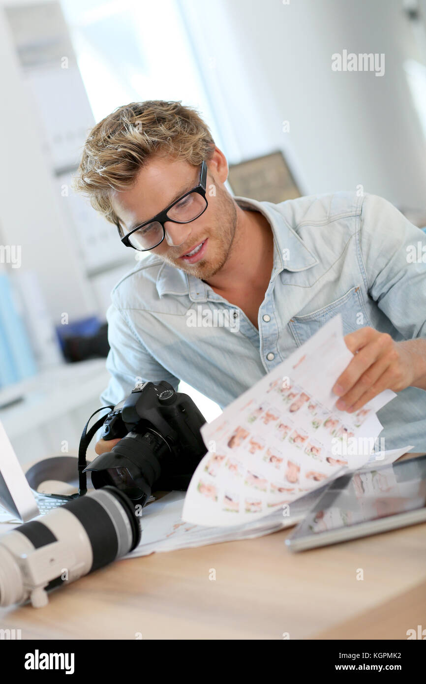 Portrait of young photographer reporter in office Stock Photo - Alamy