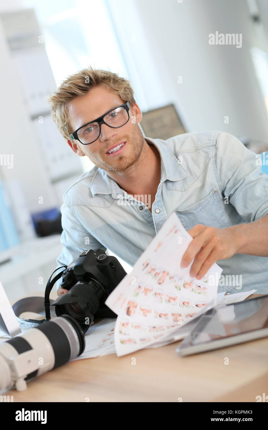 Portrait of young photographer reporter in office Stock Photo - Alamy