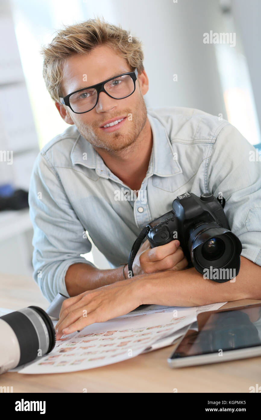 Portrait of young photographer reporter in office Stock Photo - Alamy