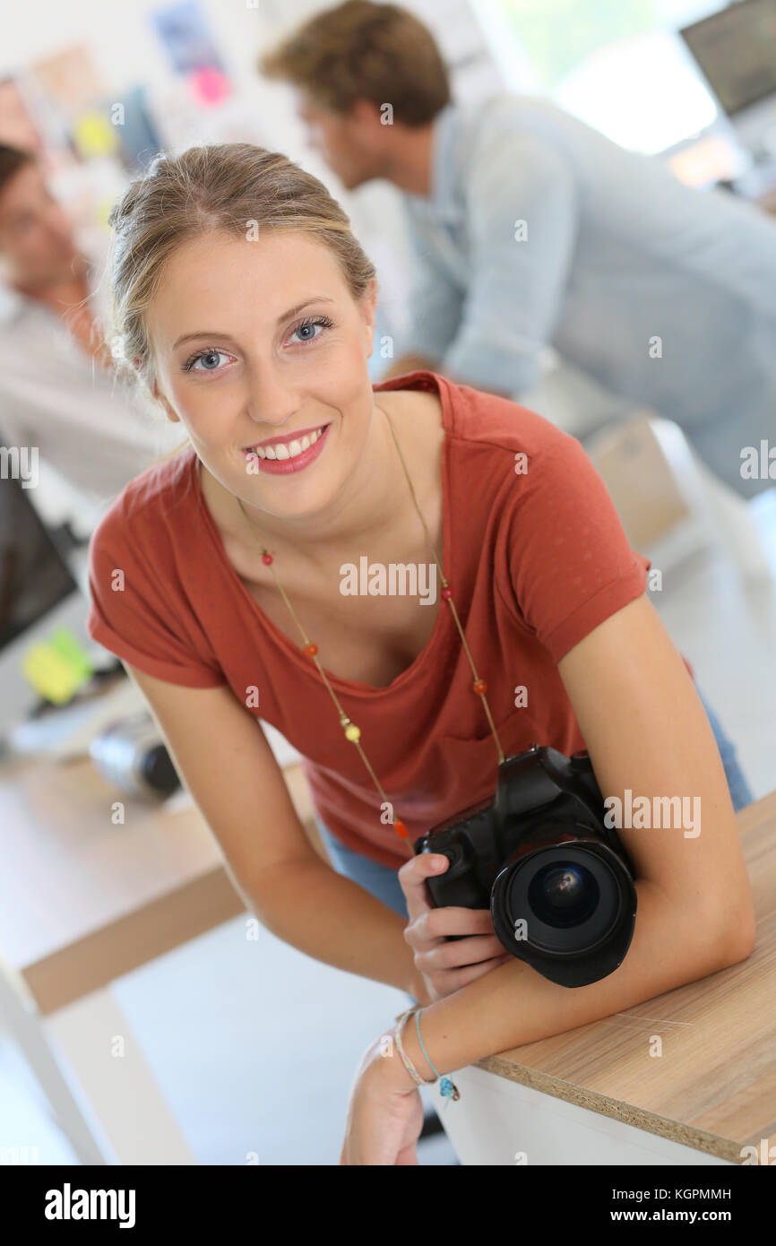 Cheerful young woman in photography training class Stock Photo - Alamy