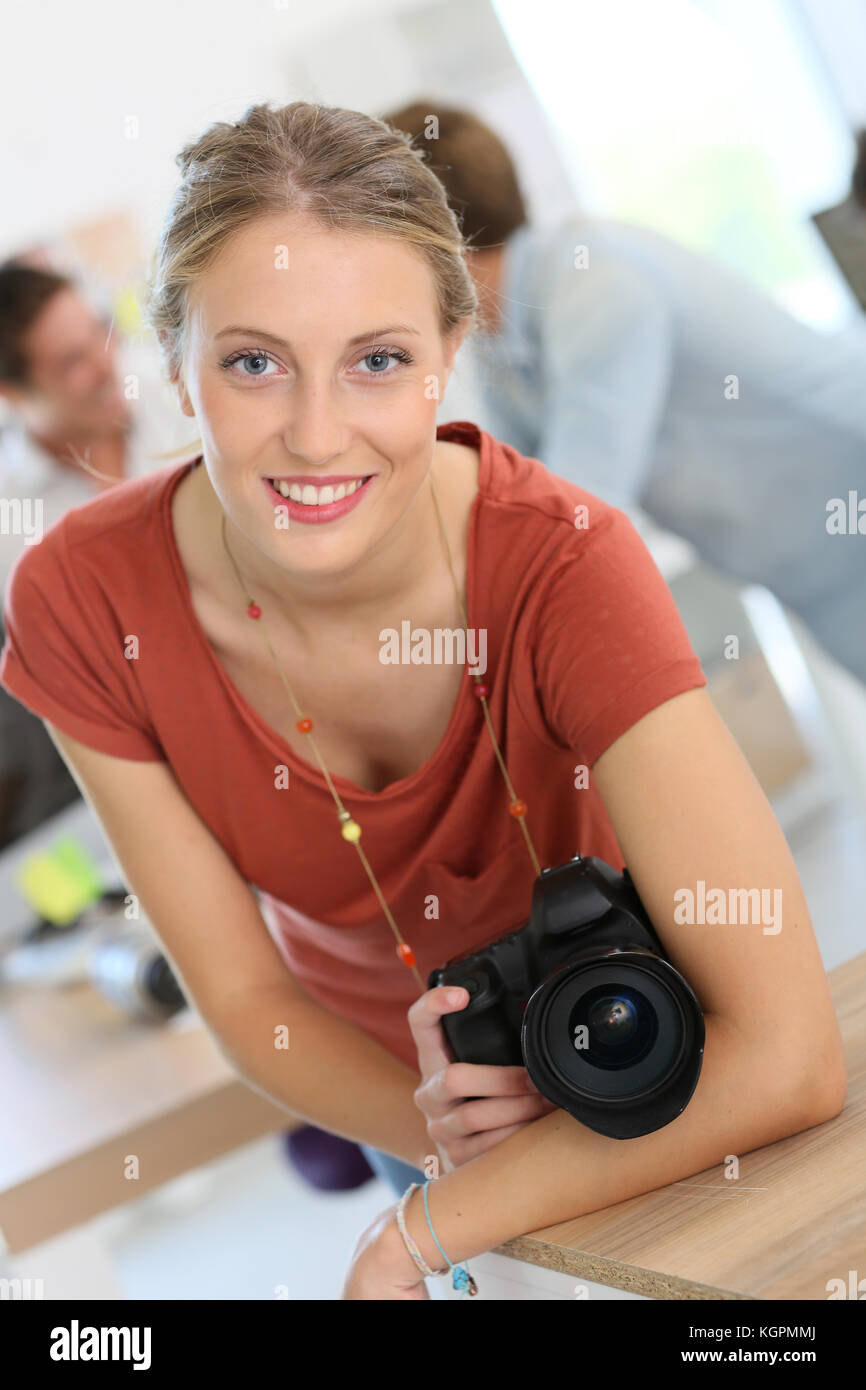 Cheerful young woman in photography training class Stock Photo - Alamy