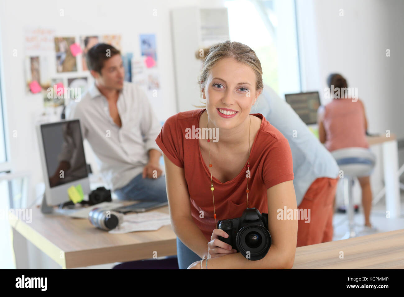 Cheerful young woman in photography training class Stock Photo - Alamy