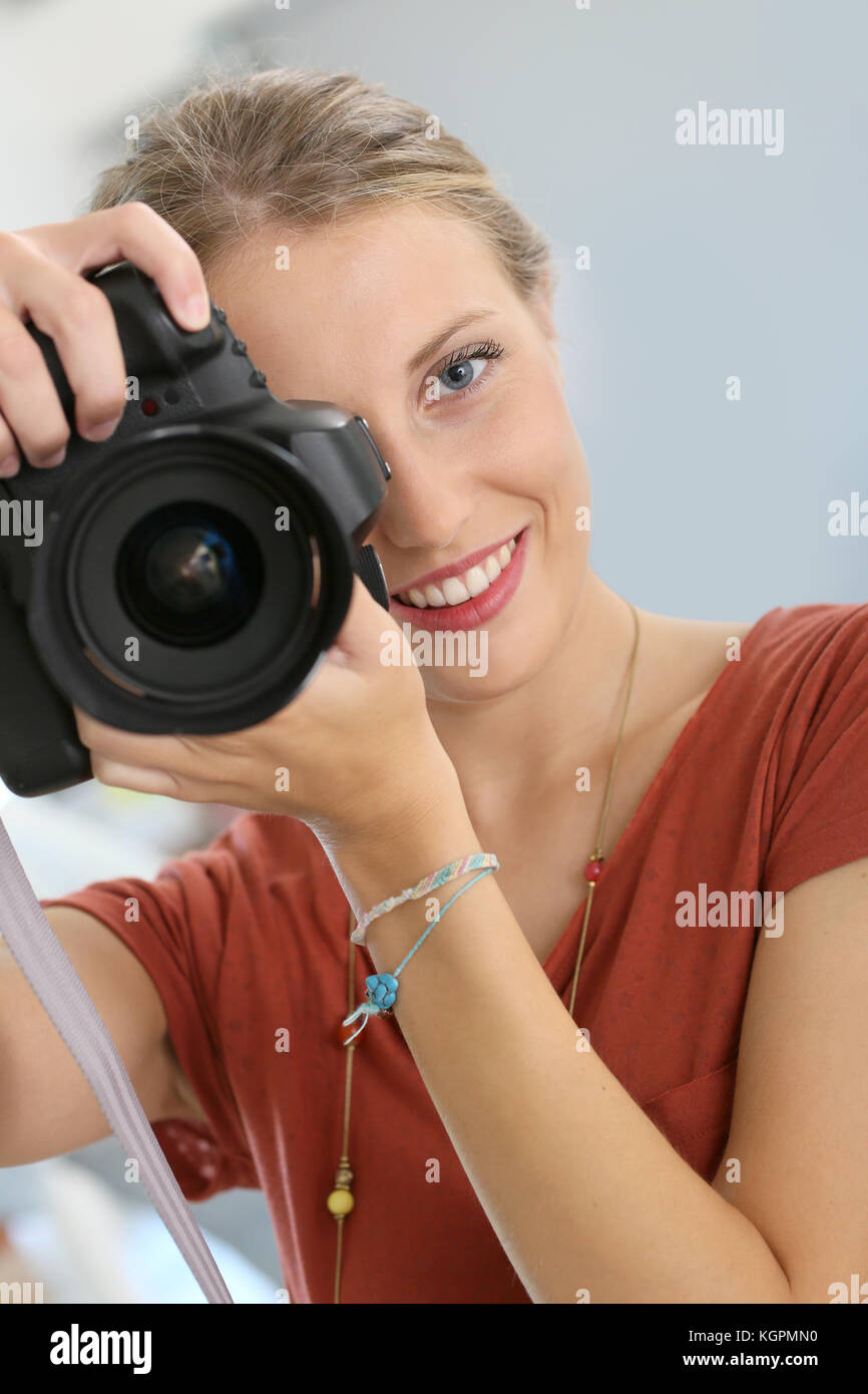 Cheerful young woman in photography training class Stock Photo - Alamy